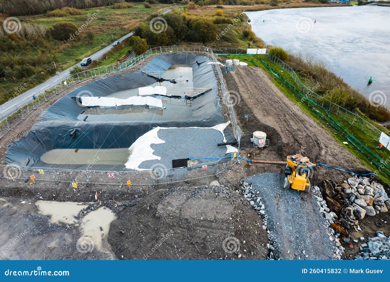 Construction Site by a Rive with Heavy Machinery. Aerial View Stock ...