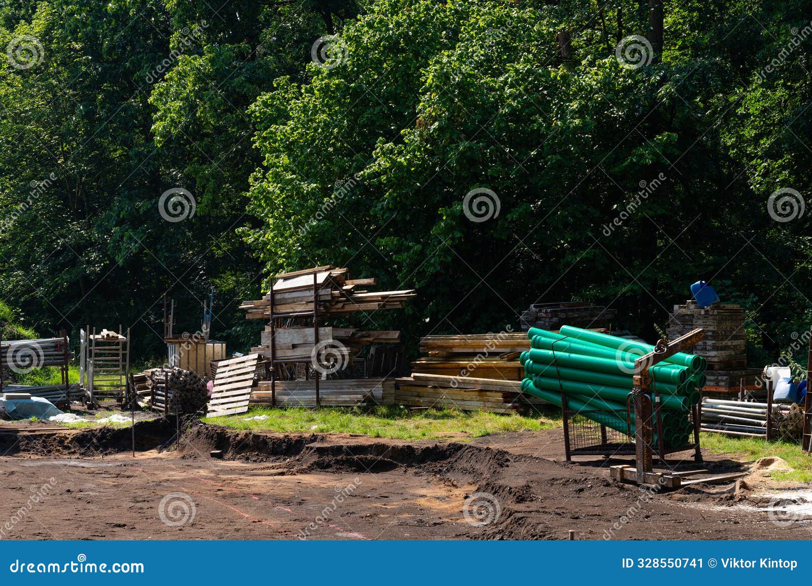 Construction Site with Stacked Materials and Equipment Surrounded by ...
