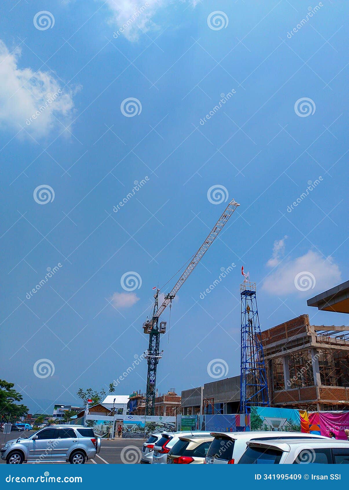 Modern Urban Development with Tower Crane Against Vibrant Blue Sky ...