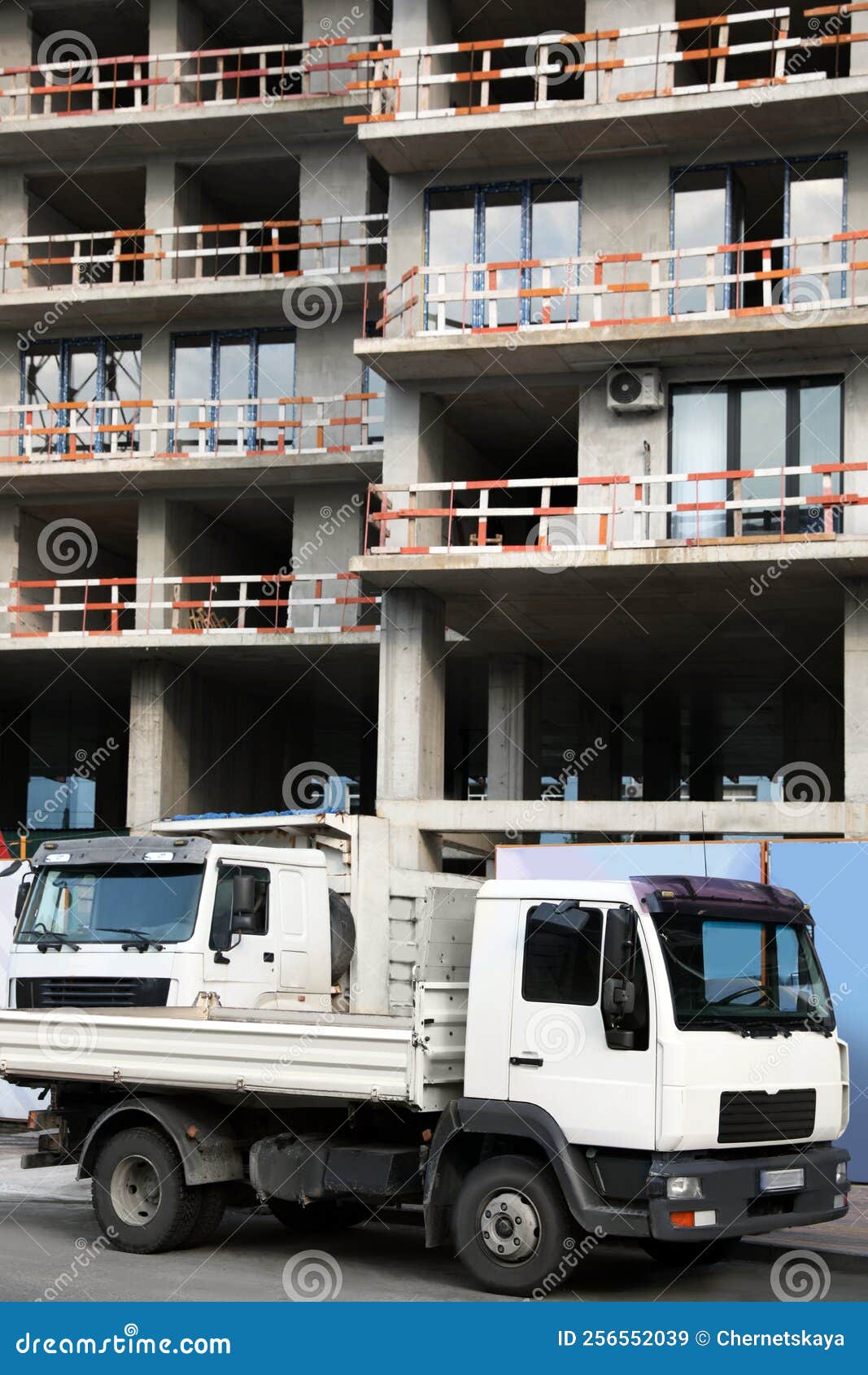Construction Site with Unfinished Building and Trucks Outdoors Stock ...