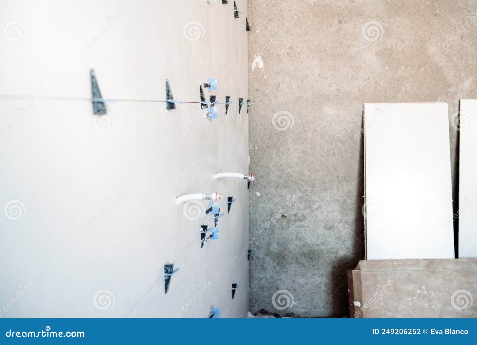 Construction Site. White Modern Tiles on Bathroom with Separator and ...
