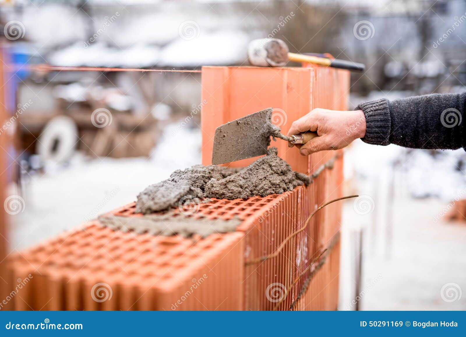 Building Brick Block Wall On Construction Plant.Worker Builds A Brick ...