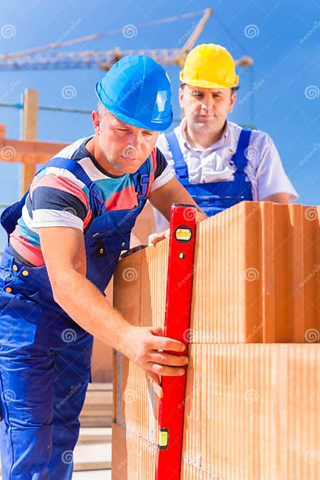 Construction Site Workers Checking Building Shell Stock Photo - Image ...