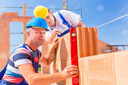 Construction Site Workers Checking Building Shell Stock Image - Image ...
