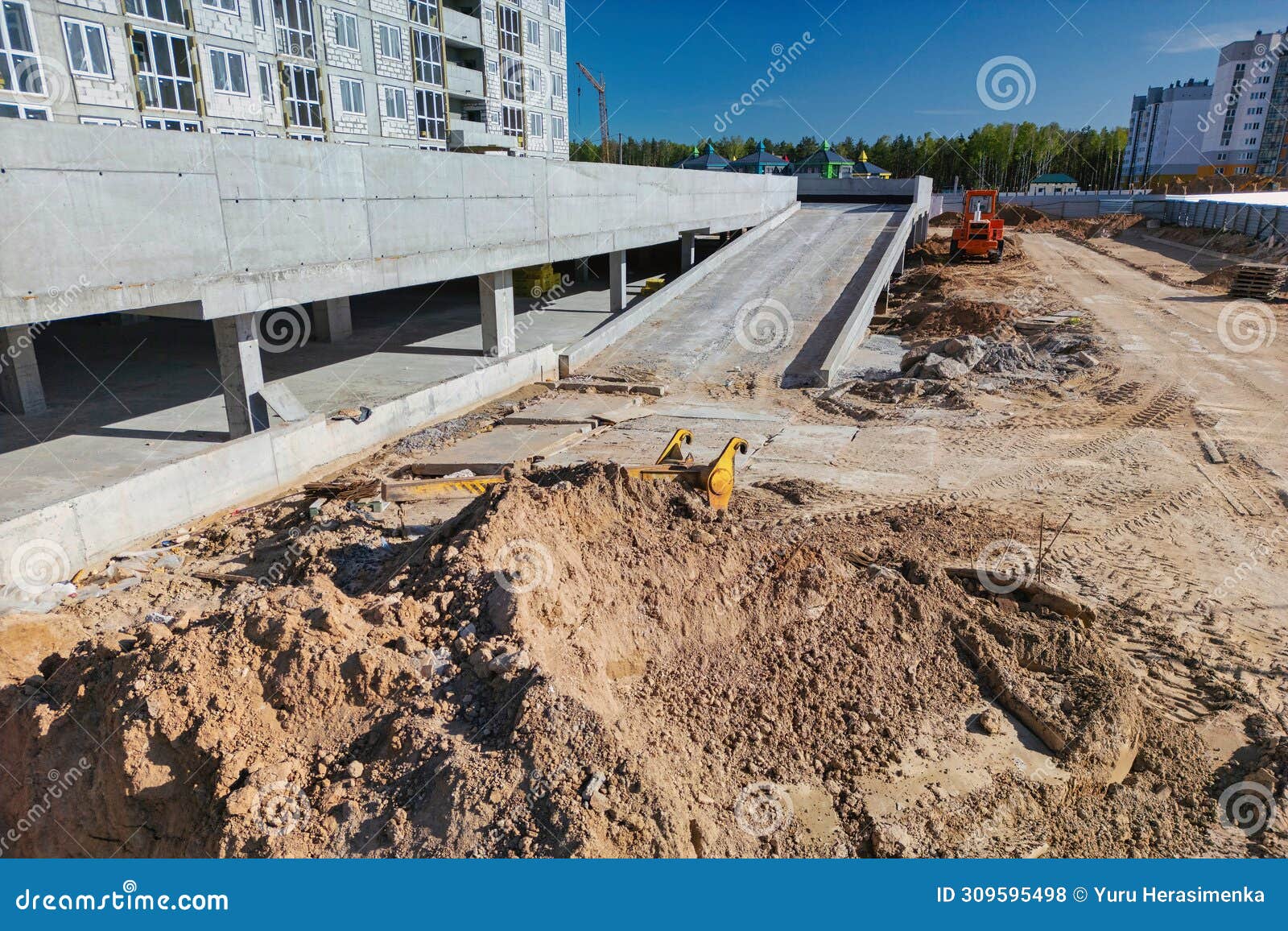 A Construction Site with Workers and Machinery in Front of a Massive ...
