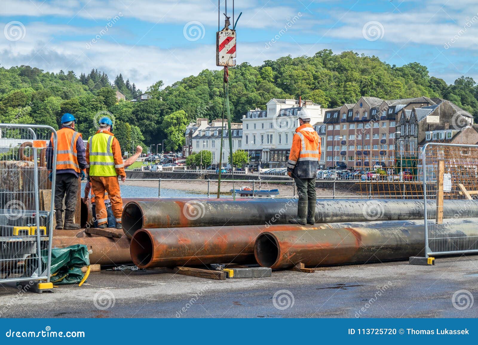 Construction Site Workers Moving Huge Pipes Editorial Image - Image of ...