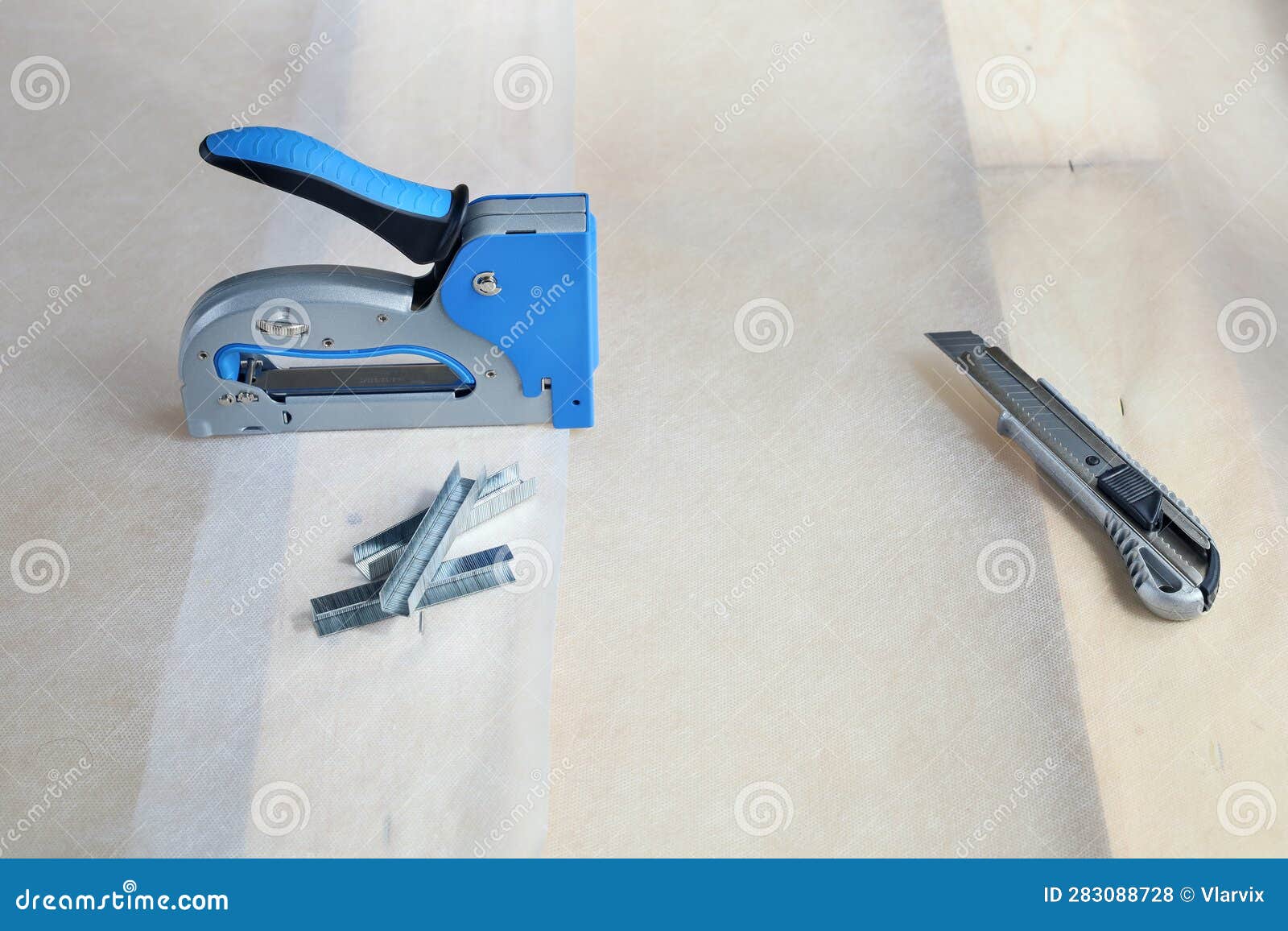 Construction Stapler, Sharp Knife and Staples are on Surface of ...