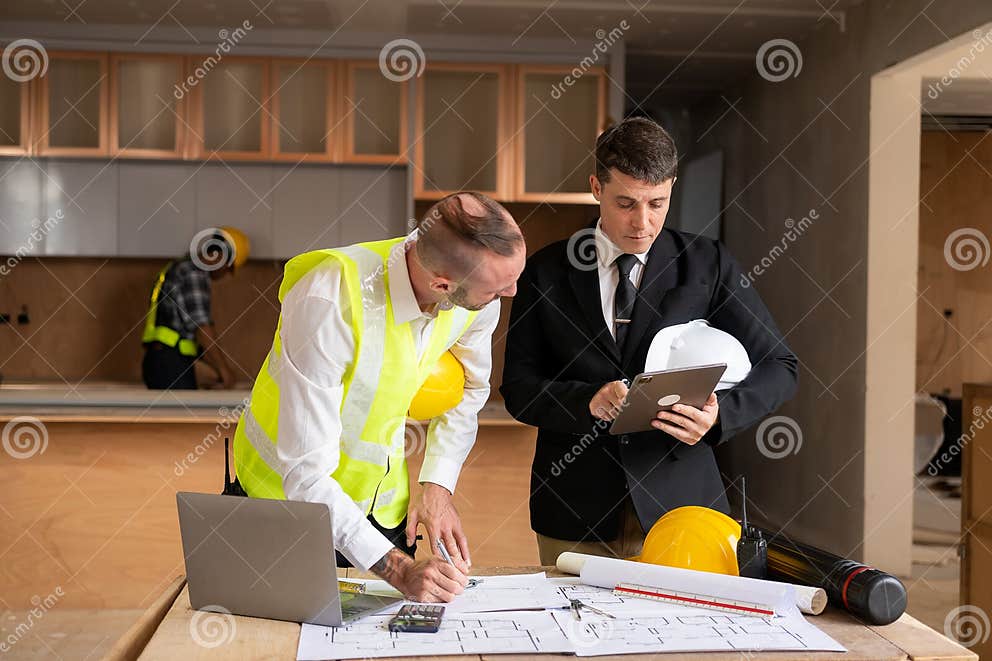 Construction and Structural Concept Engineers Working on Drawings at ...