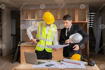 Construction and Structural Concept Engineers Working on Drawings at ...