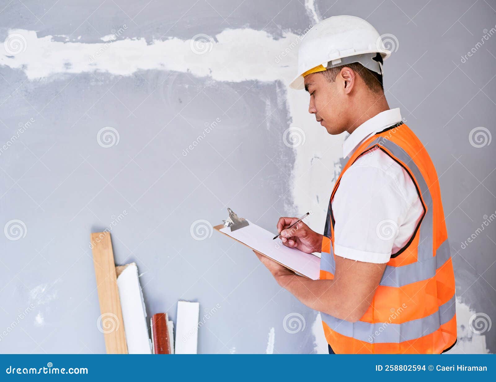 A Construction Supervisor Checks Renovation Project with Checklist on ...
