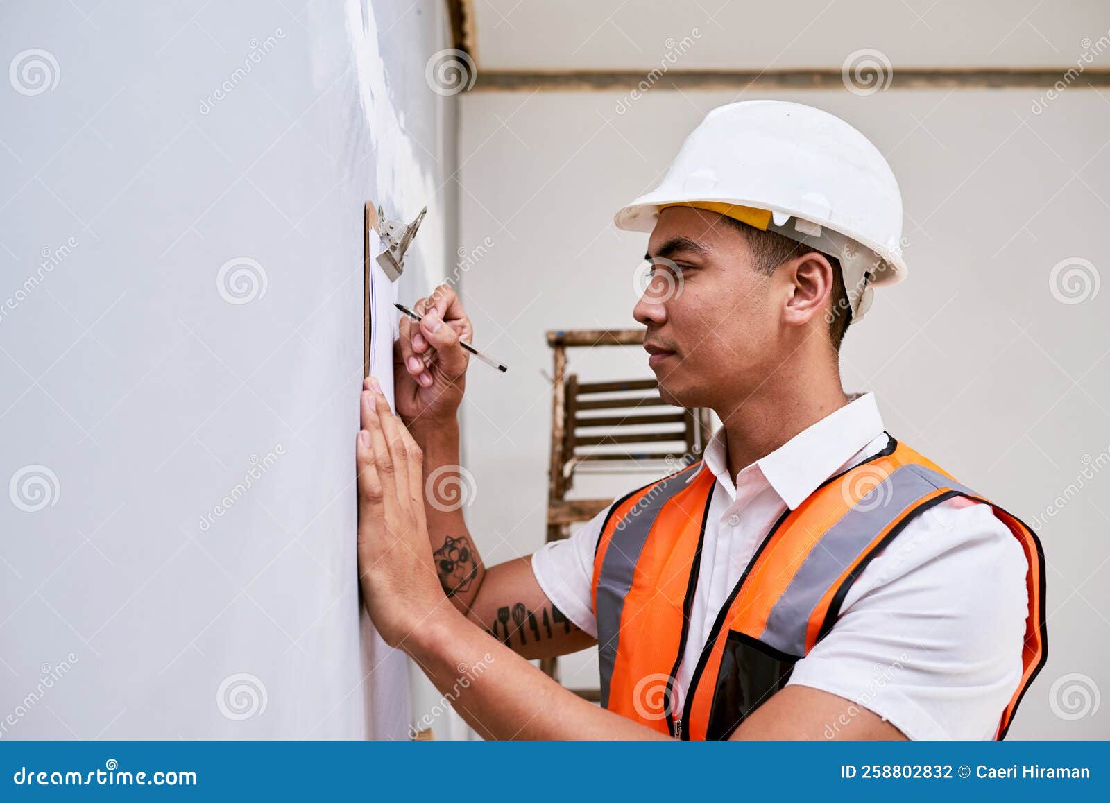 A Construction Supervisor Checks Renovation Project with Checklist on ...