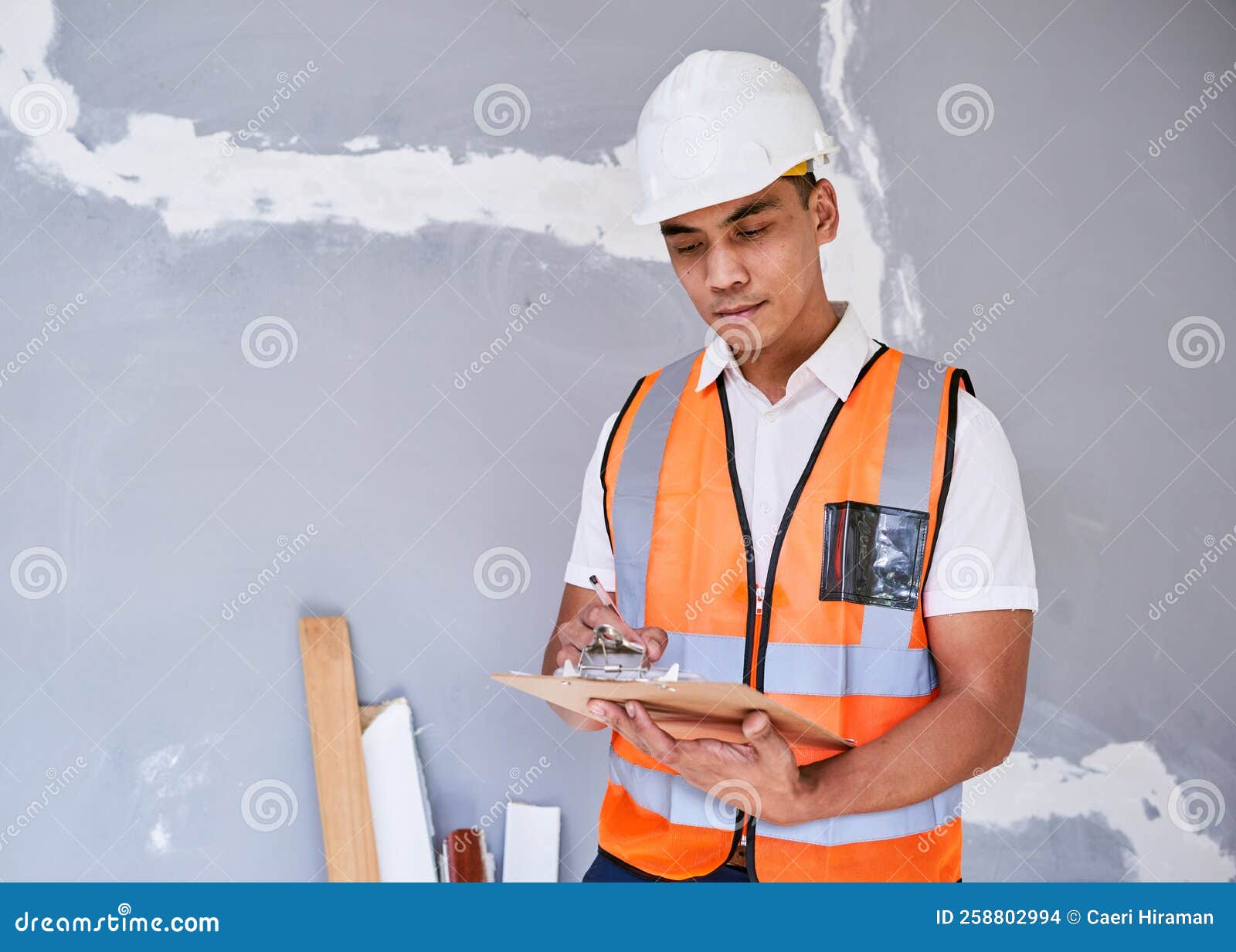 A Construction Supervisor Checks Renovation Project with Checklist on ...
