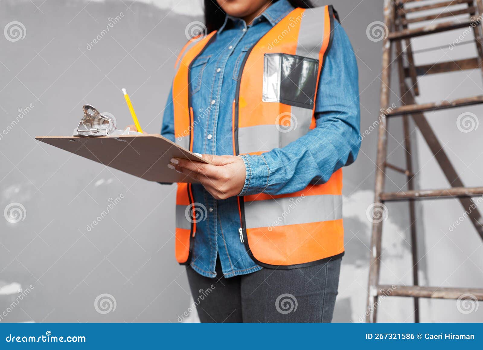 A Construction Supervisor Checks Renovation Project with Checklist on ...
