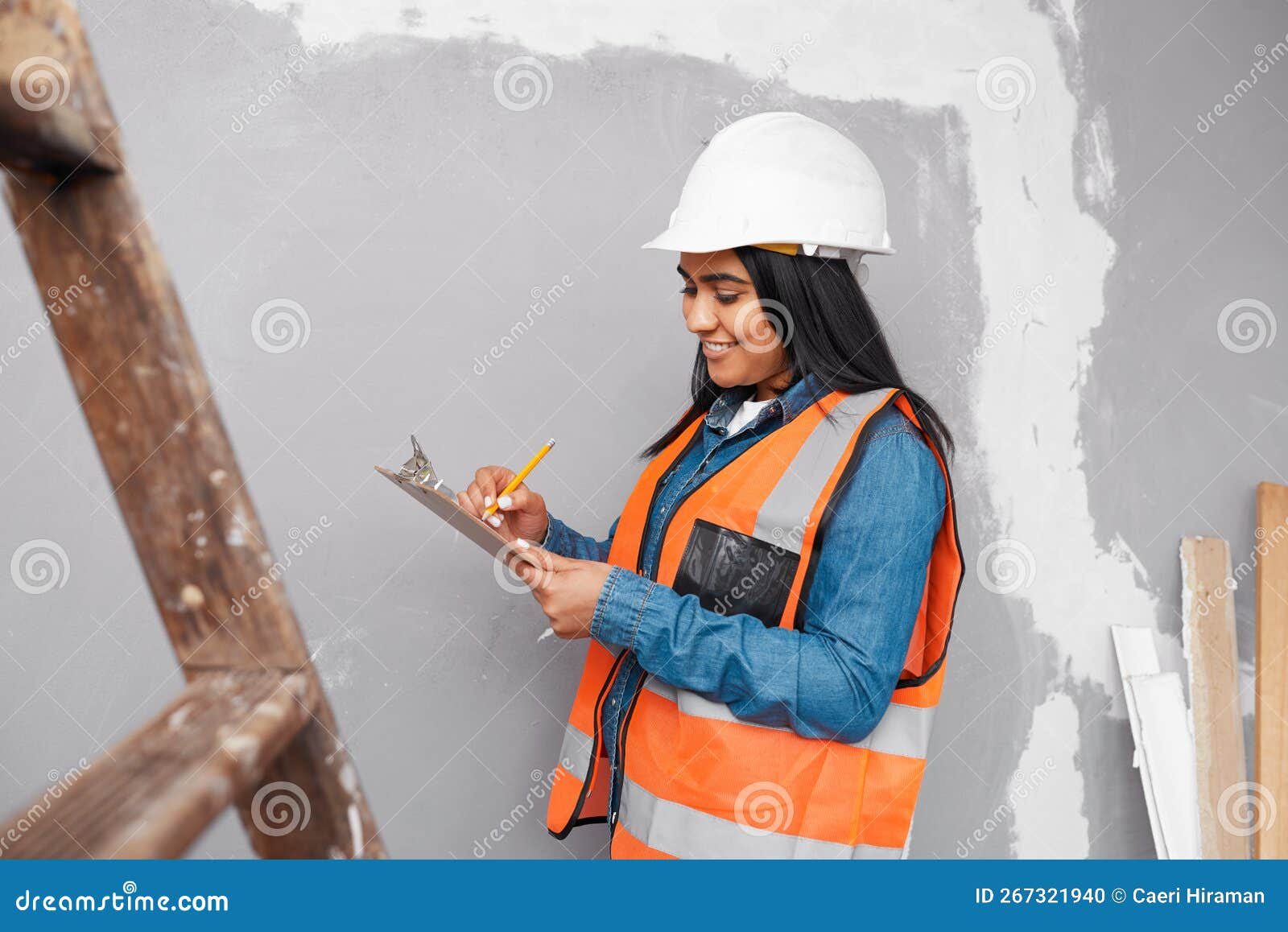 A Construction Supervisor Checks Renovation Project with Checklist on ...