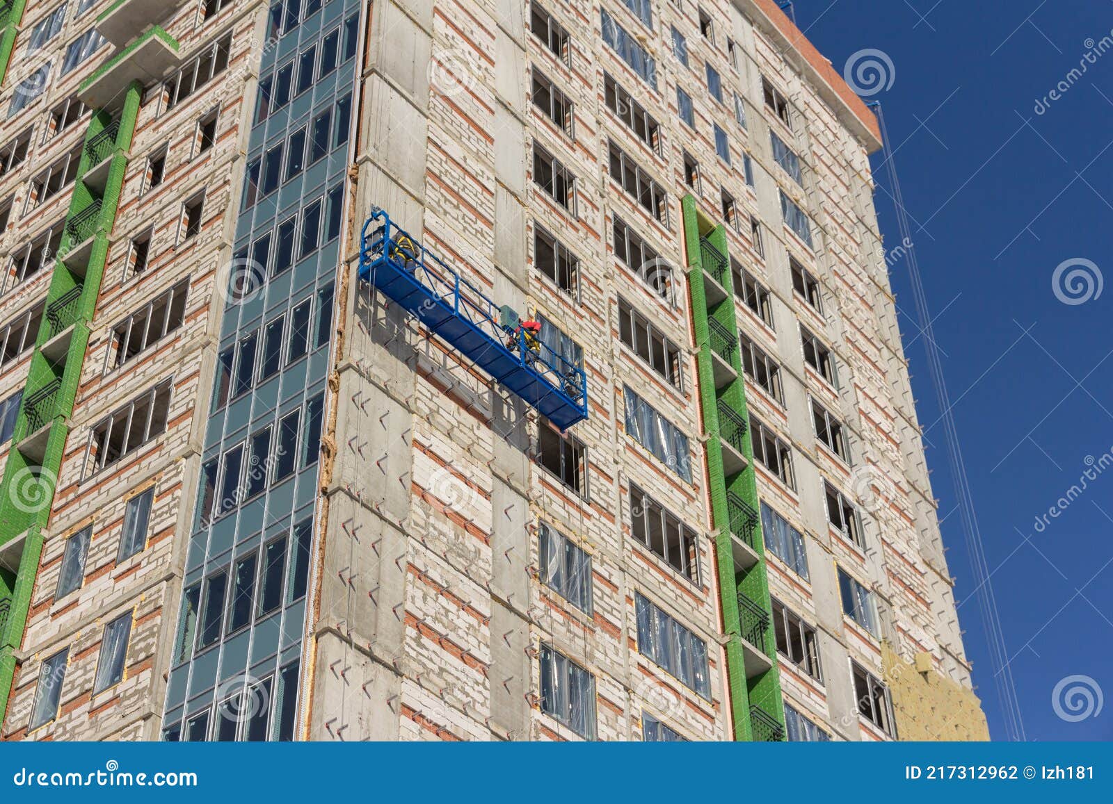 Construction Cradle with Workers on the Facade of the Building ...
