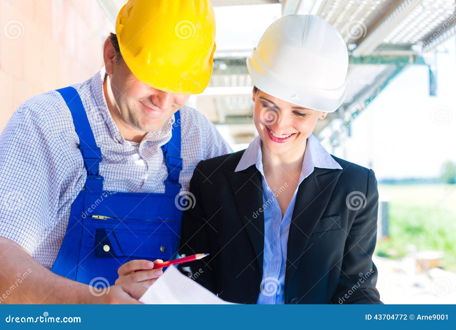 Construction Team with Building Plans on Site Stock Photo - Image of ...