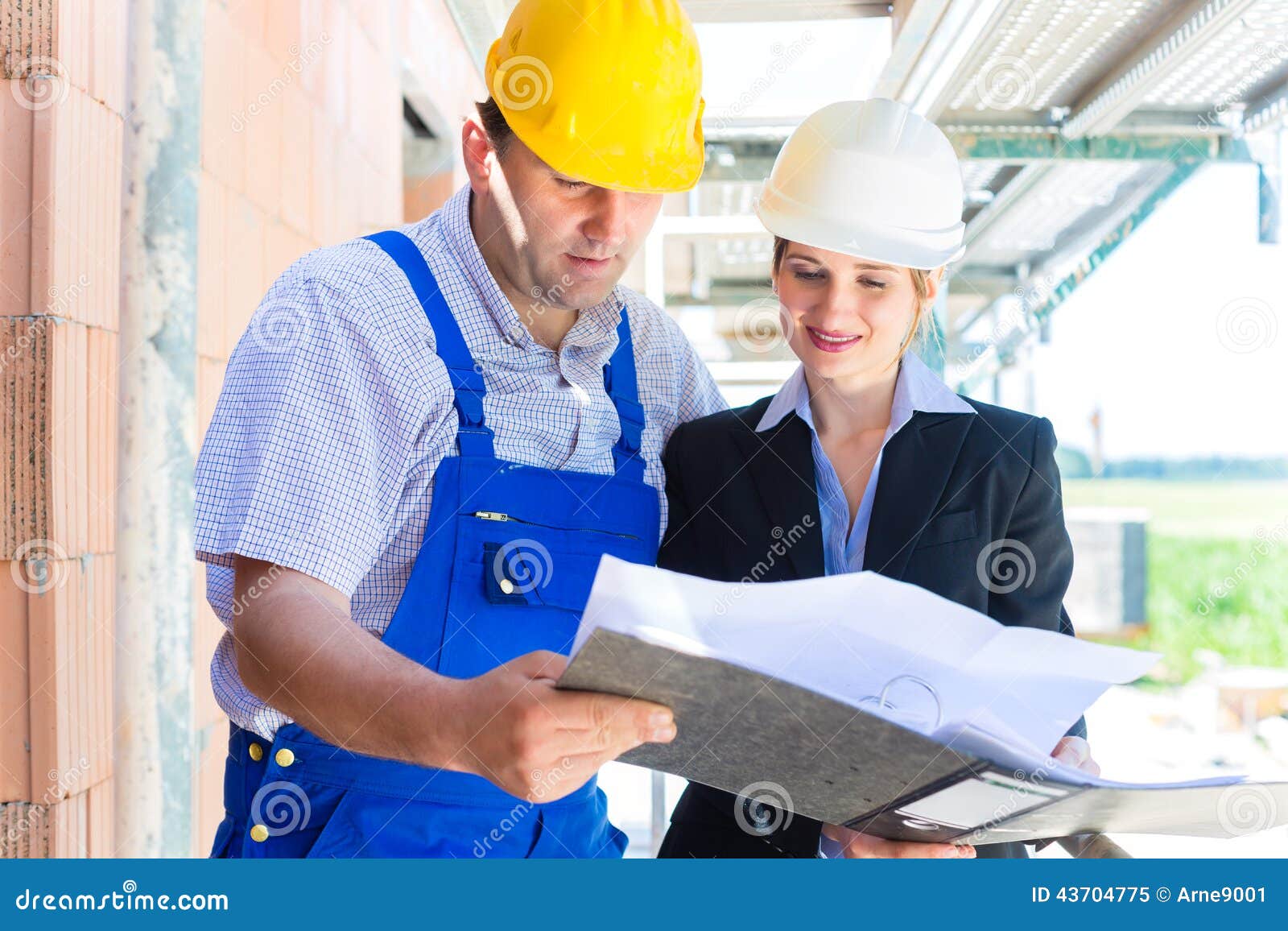 Construction Team with Building Plans on Site Stock Image - Image of ...