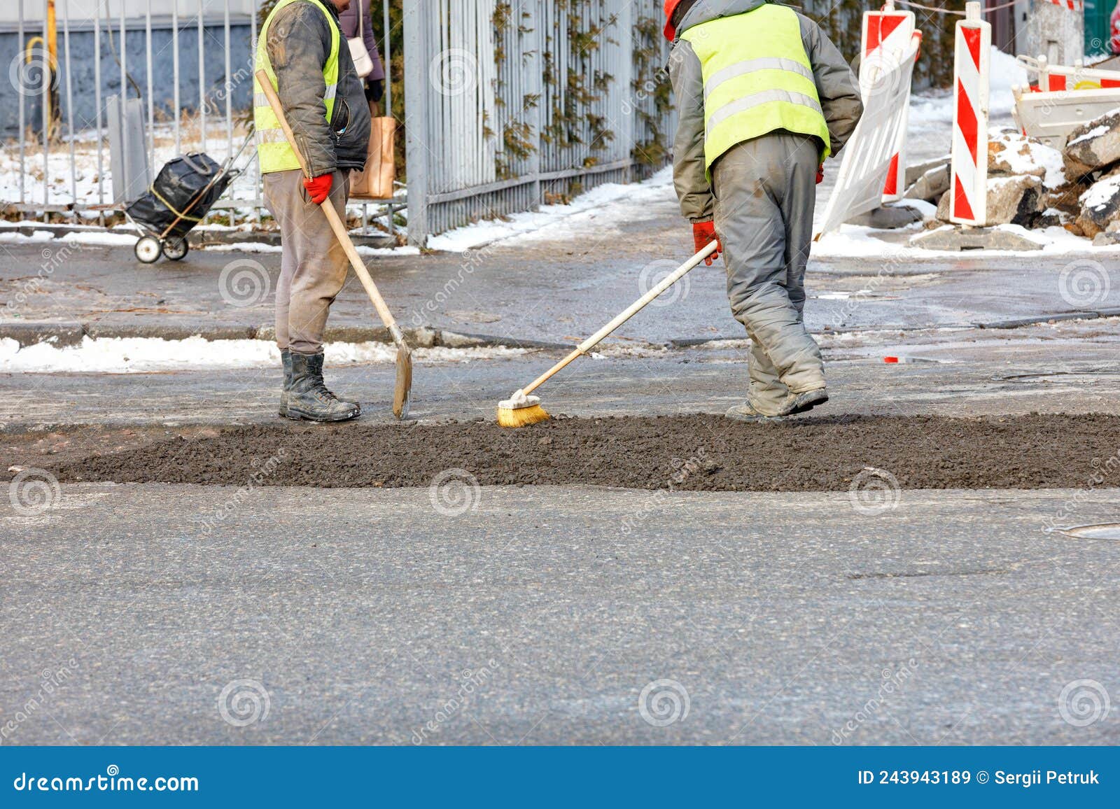 A Construction Team is Patching Up the Pavement of the Carriageway ...