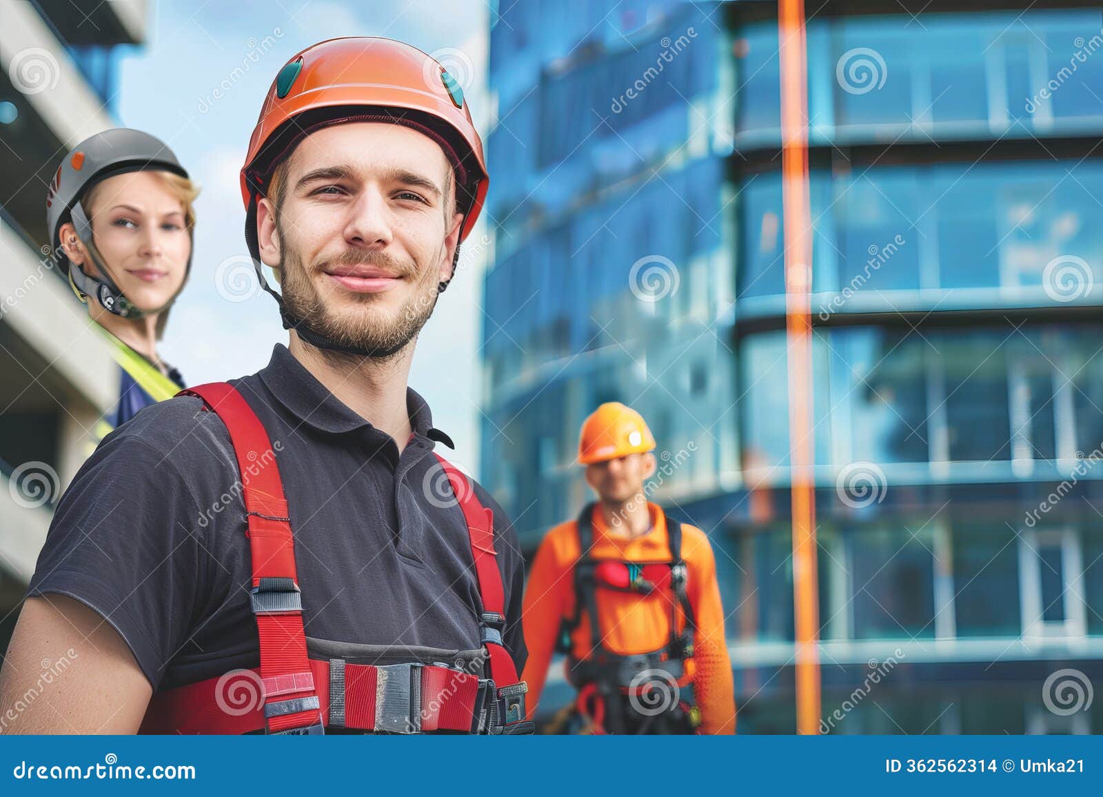 Construction Team in Safety Gear on Worksite with Modern Building in ...