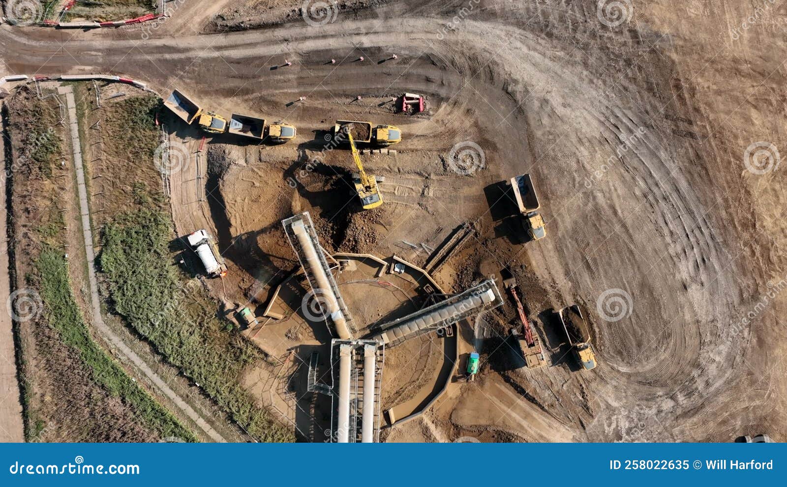 Construction Tipper Trucks Being Loaded Up with Earth by a Digger Stock ...