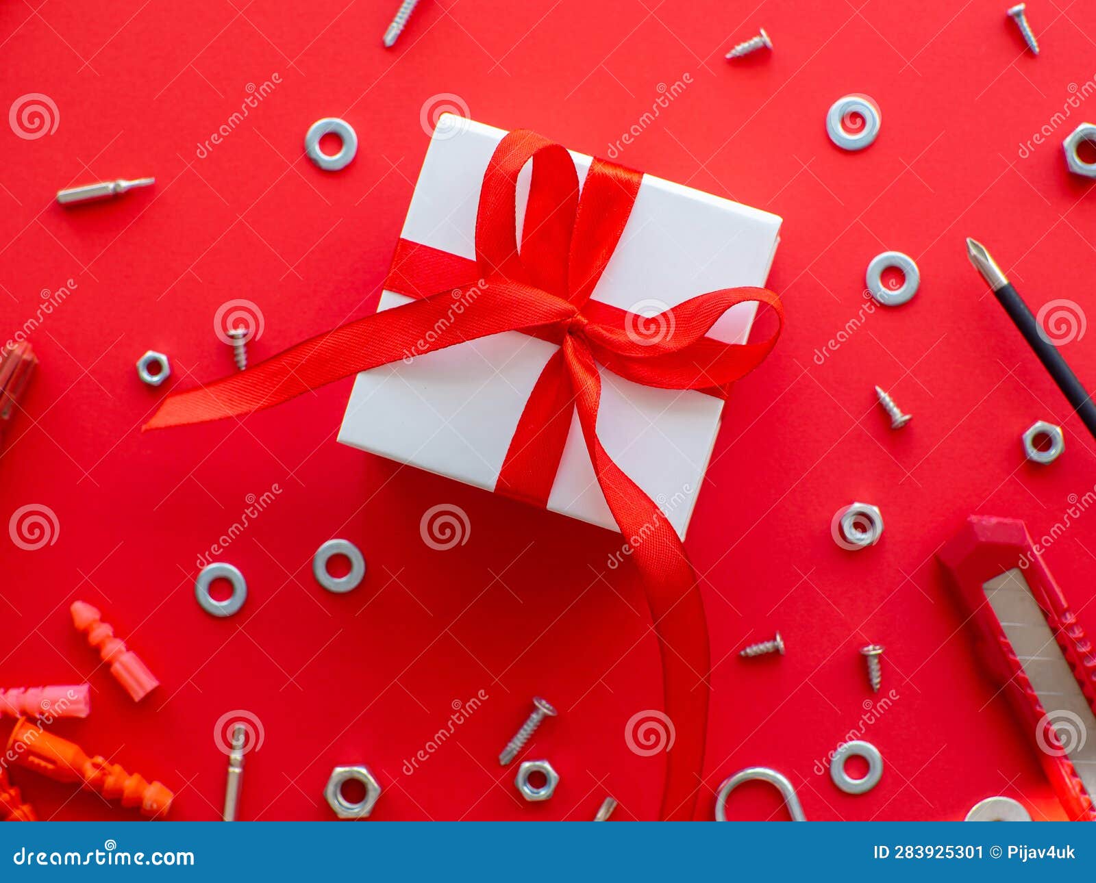 Construction Tools and Wrapped Gift on Red Background Stock Image ...