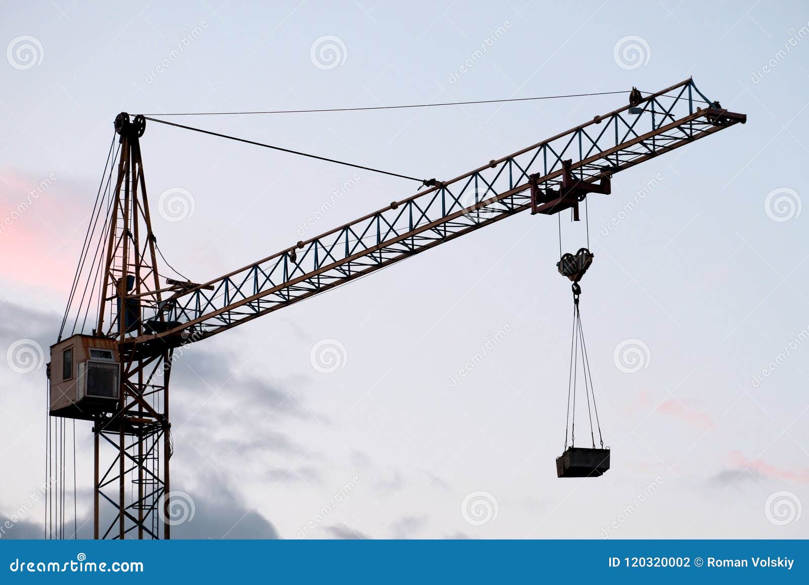 Construction Tower Crane with a Load Against the Background of the ...