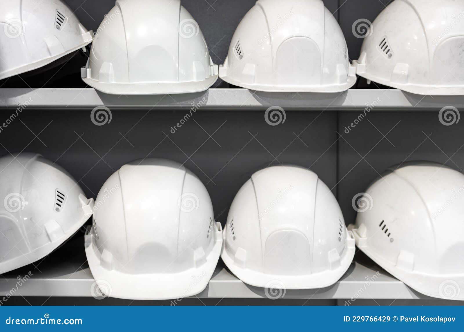 Construction White Helmets Stand in a Row on the Table Stock Image ...