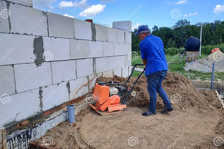 Construction Work on the Construction Site, Soil Compaction with a ...