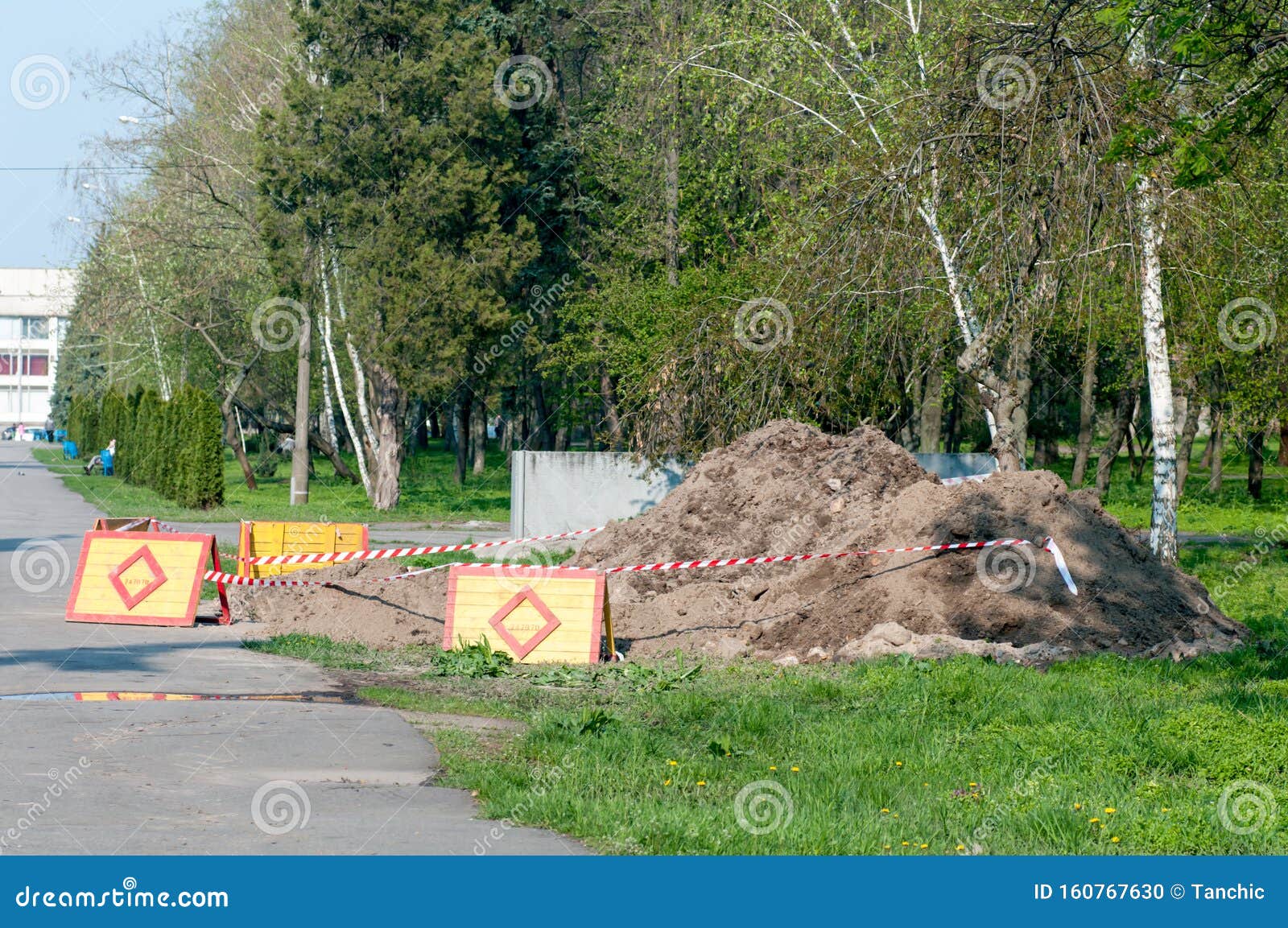 Construction Work, a Dug Hole with a Warning Sign in the Park Stock ...