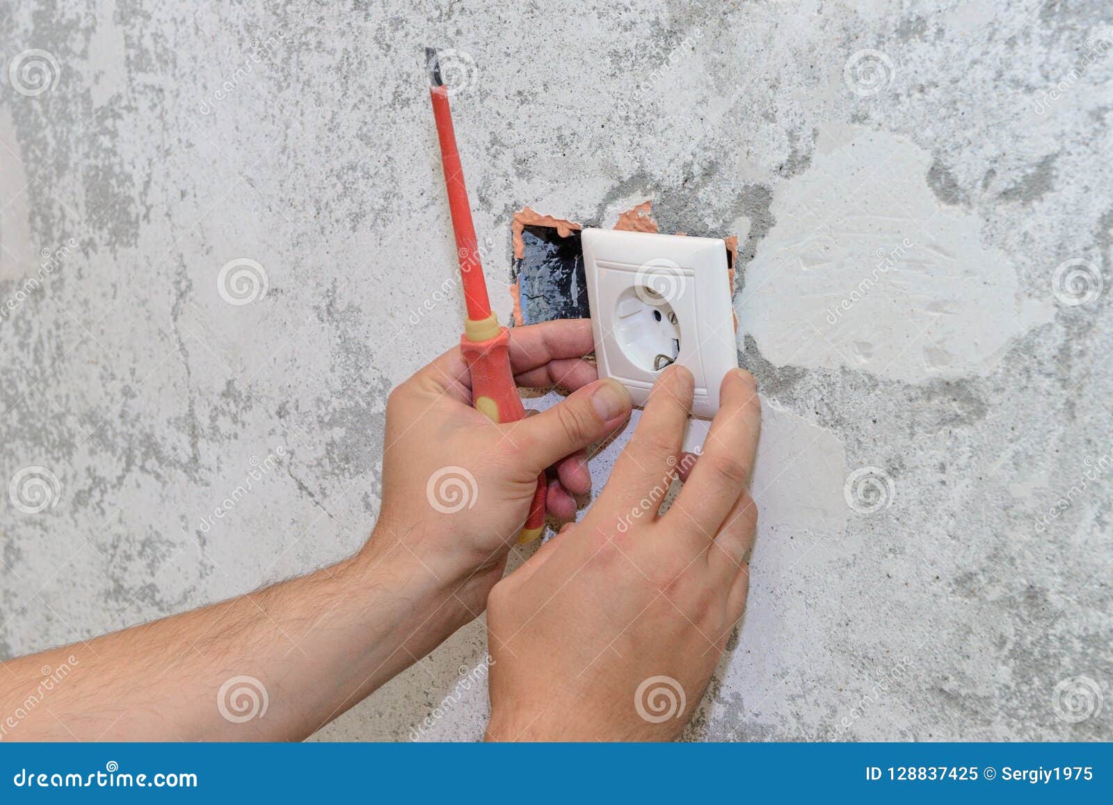 Construction Work, the Electrician Installs the Socket Stock Image ...