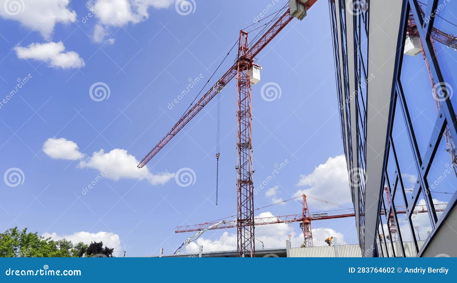 Construction Work with a High-rise Crane on a Blue Sky Background ...