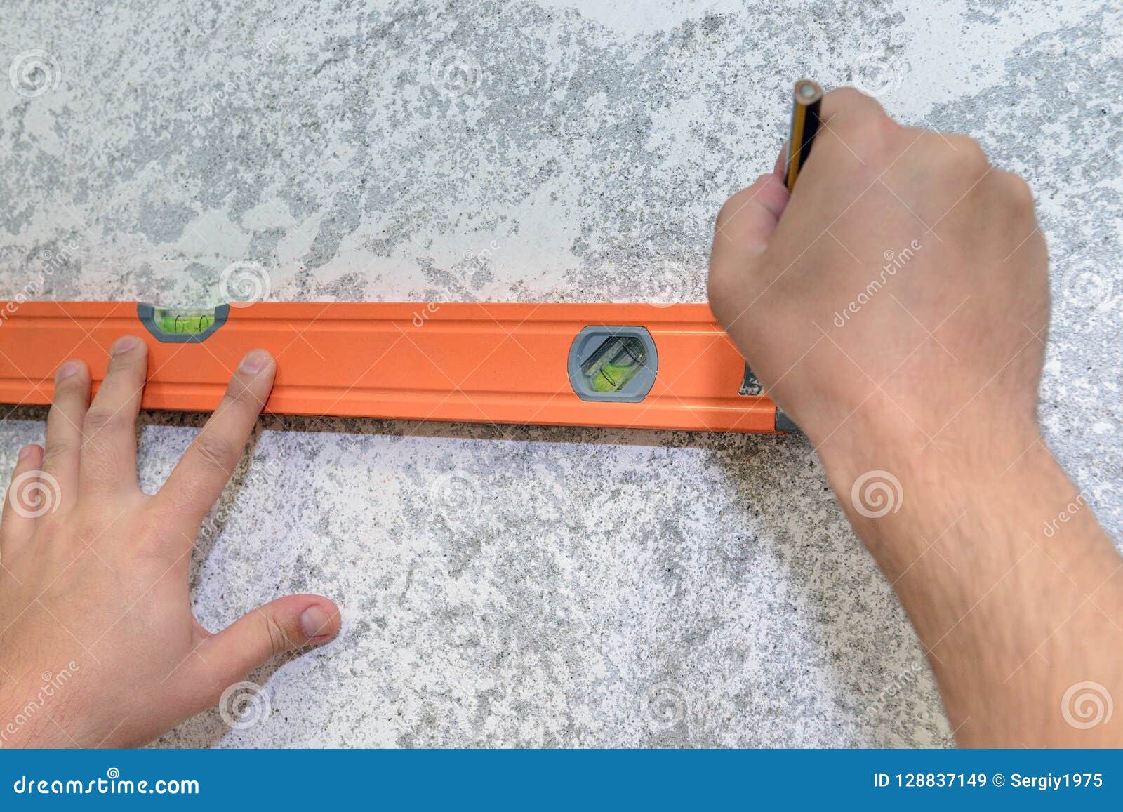 Construction Work Marking with a Pencil on the Wall with a Building ...