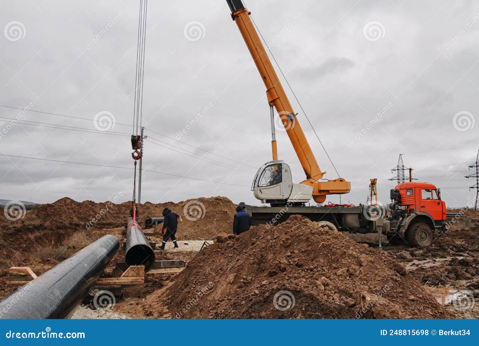 Construction Work on the Pipe Laying of the Pipeline into Trench Using ...
