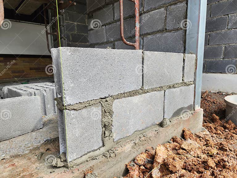 Construction Work by Putting Bricks Together and Plastering the Walls ...