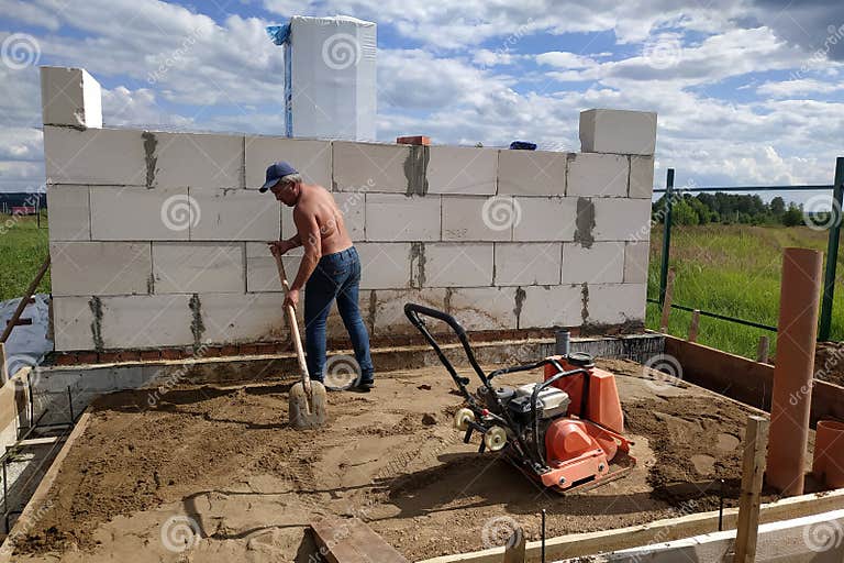 Construction Work on the Construction Site, Soil Compaction with a ...