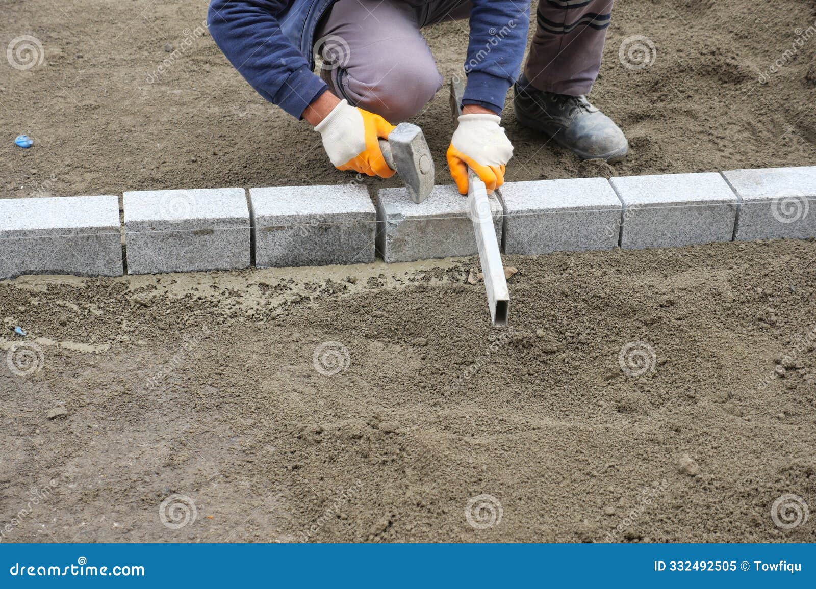 A Construction Worker Actively Engaging in the Task of Laying Paving ...