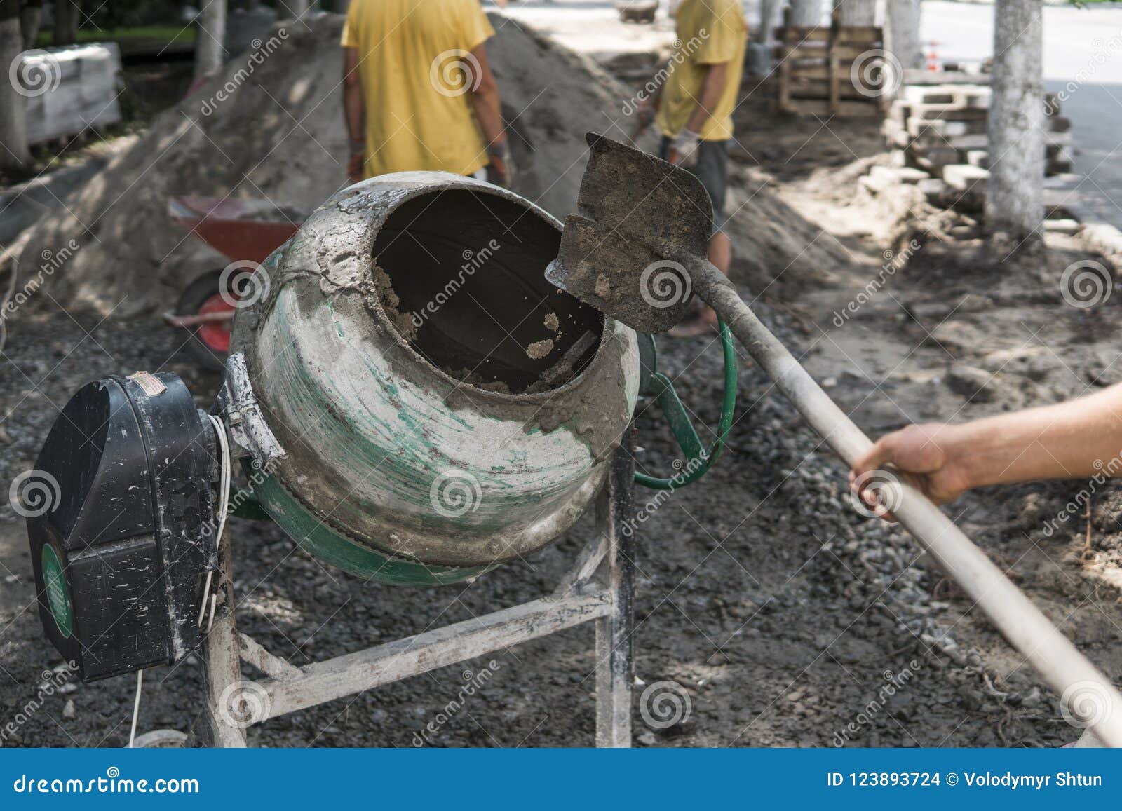 Construction Worker Add Ingredients for Mixing in the Concrete Mixer at ...