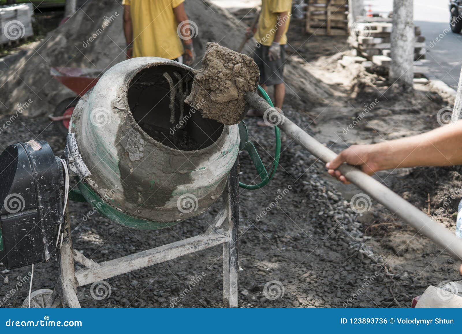 Construction Worker Add Ingredients for Mixing in the Concrete Mixer at ...