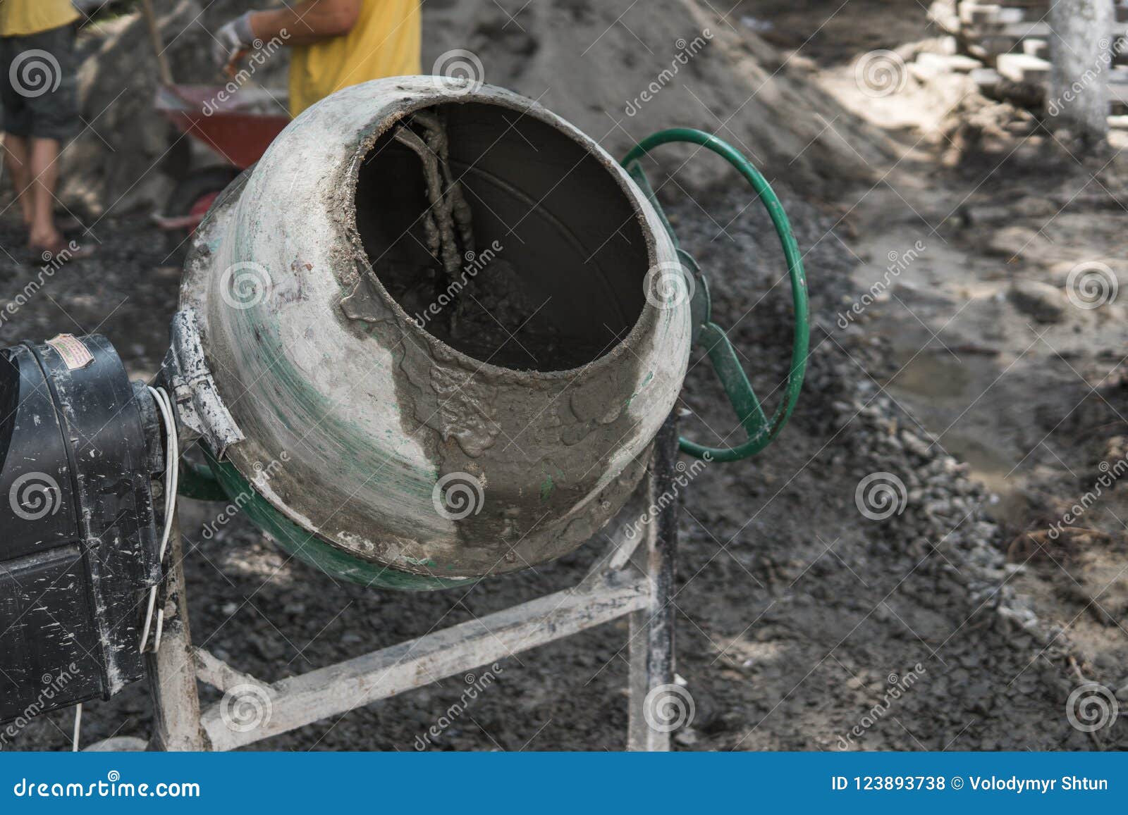 Construction Worker Add Ingredients for Mixing in the Concrete Mixer at ...