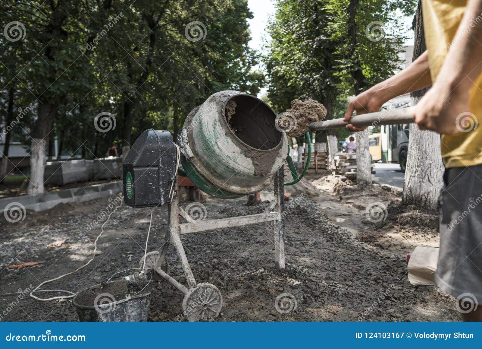Construction Worker Add Ingredients for Mixing in the Concrete Mixer at ...