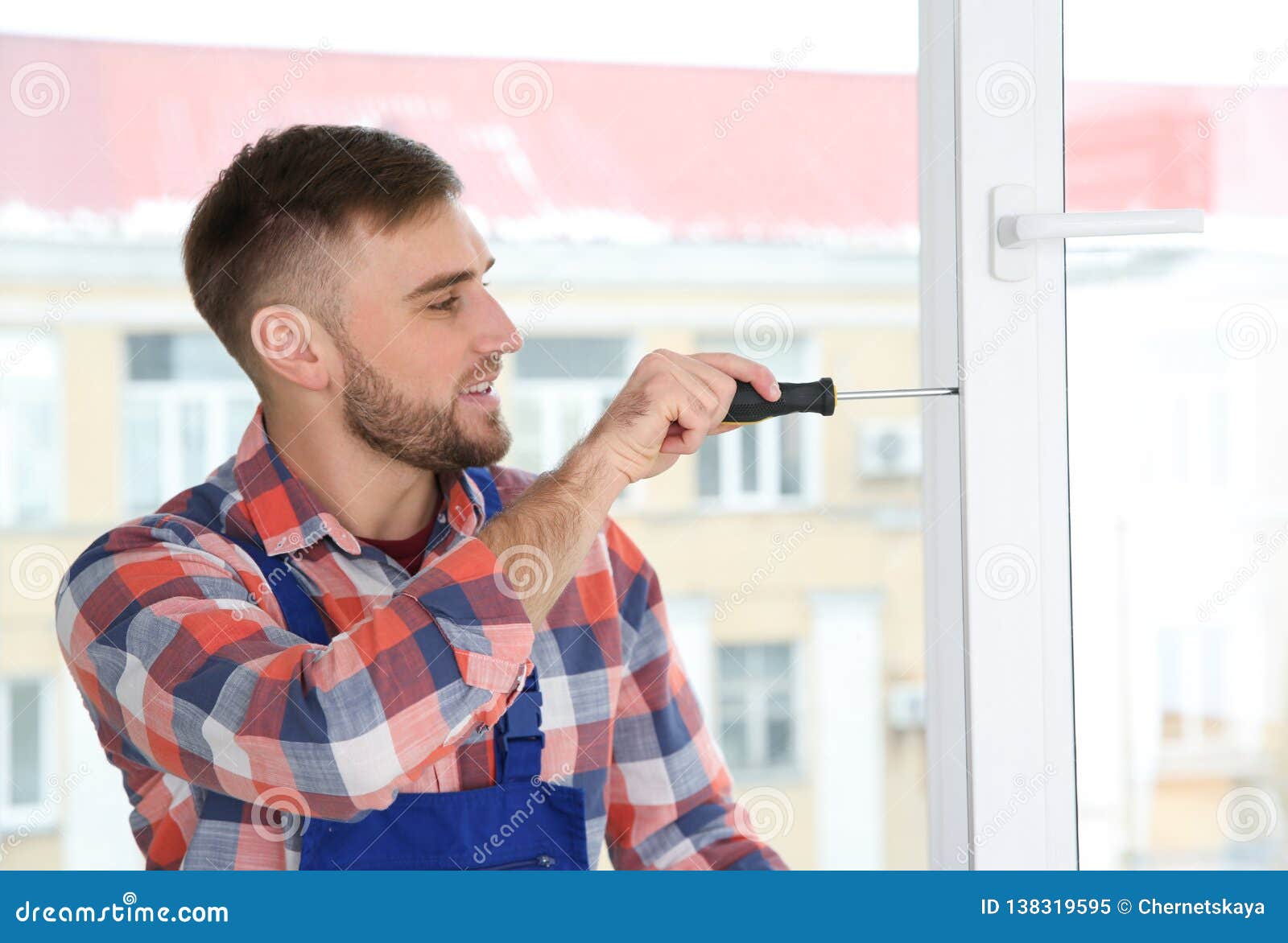 Construction Worker Adjusting Installed Window with Screwdriver Stock ...