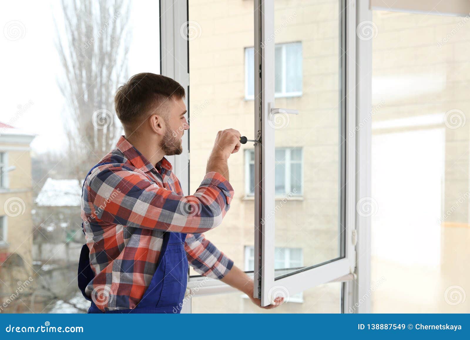 Construction Worker Adjusting Installed Window with Screwdriver Stock ...