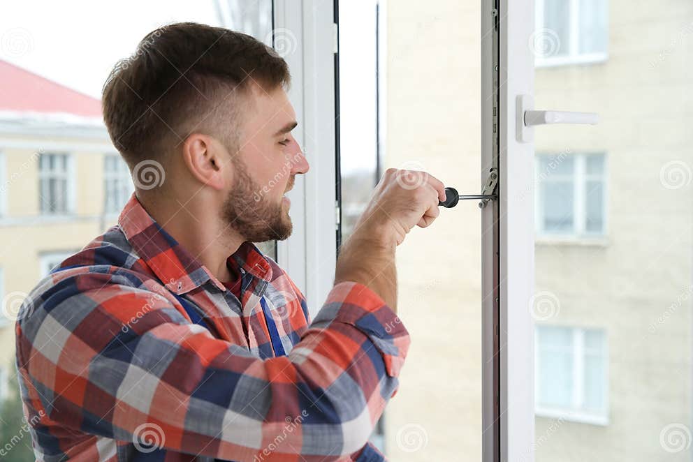 Construction Worker Adjusting Installed Window with Screwdriver Stock ...
