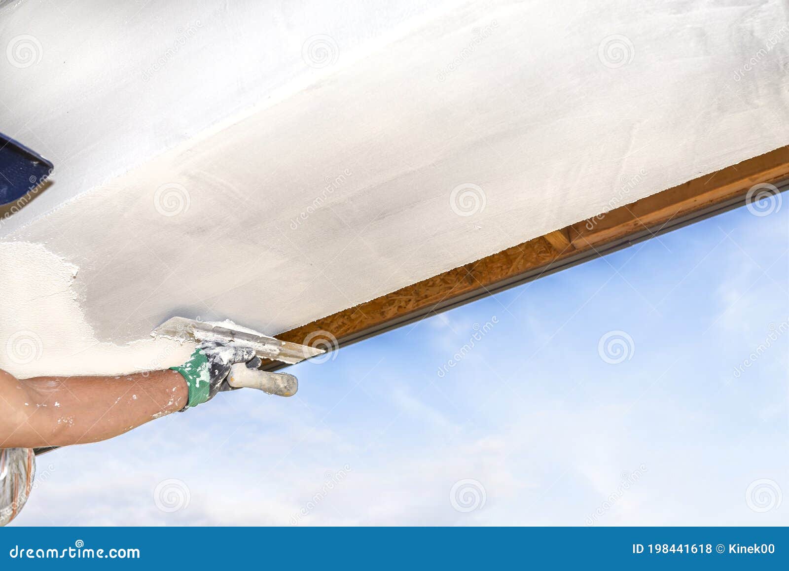 A Construction Worker Applies and Blurs a White Layer of Silicone ...