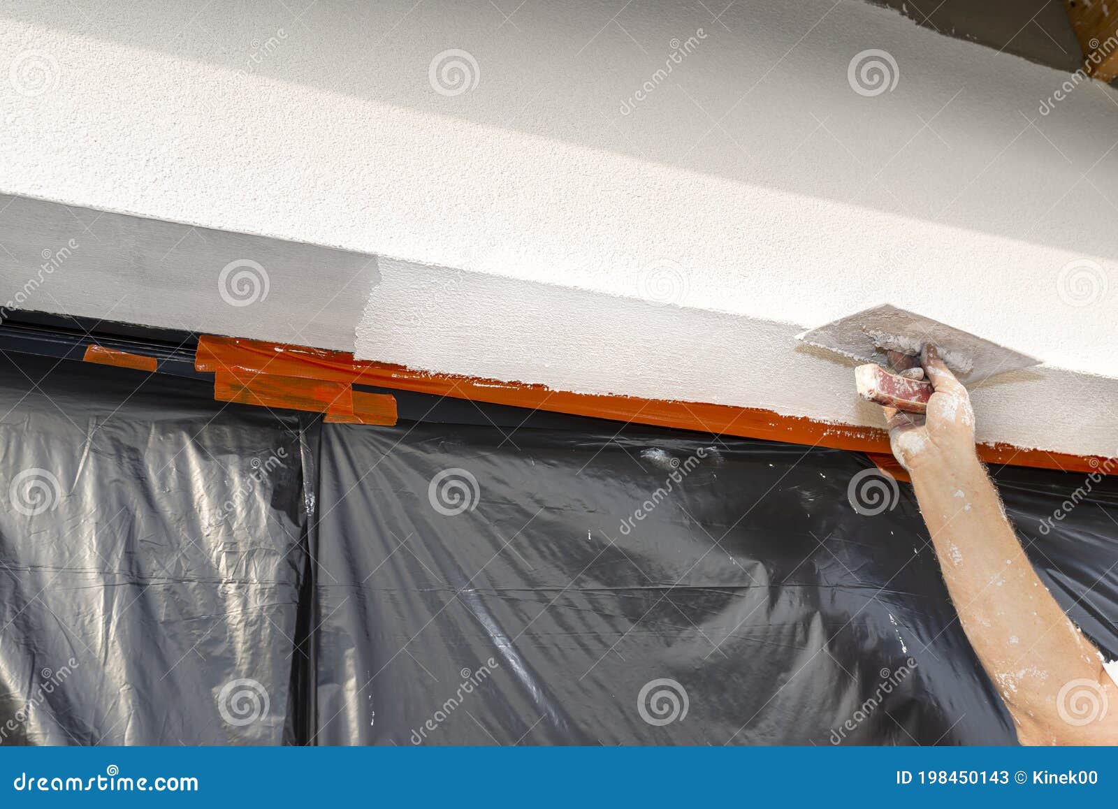 A Construction Worker Applies and Blurs a White Layer of Silicone ...