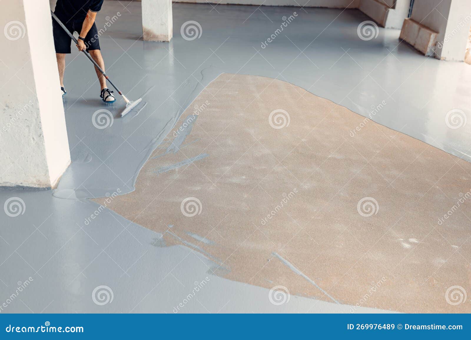 Worker Apply Grey Epoxy Resin in an Industrial Warehouse Stock Image ...