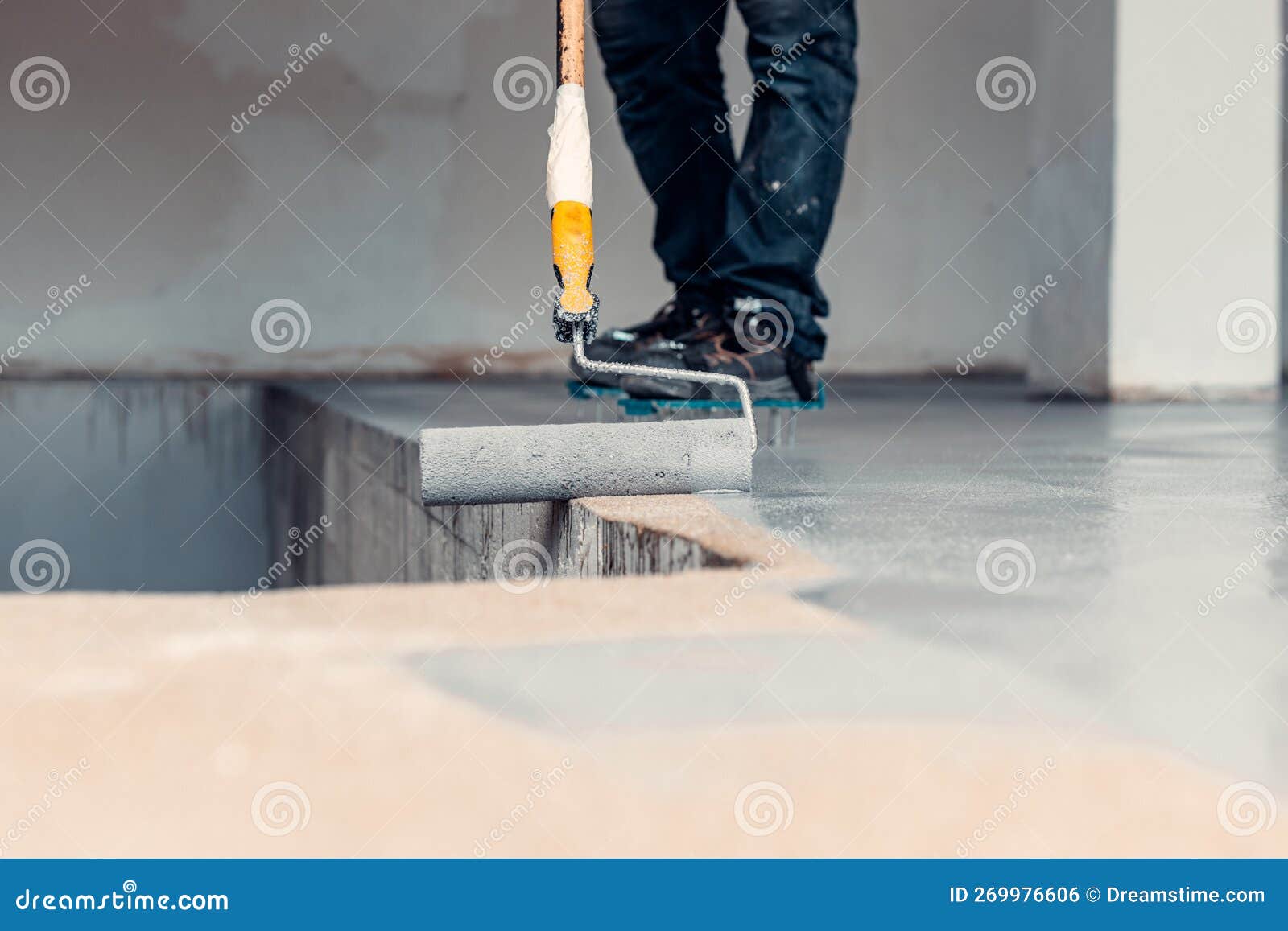 Worker Apply Grey Epoxy Resin in an Industrial Warehouse Stock Photo ...