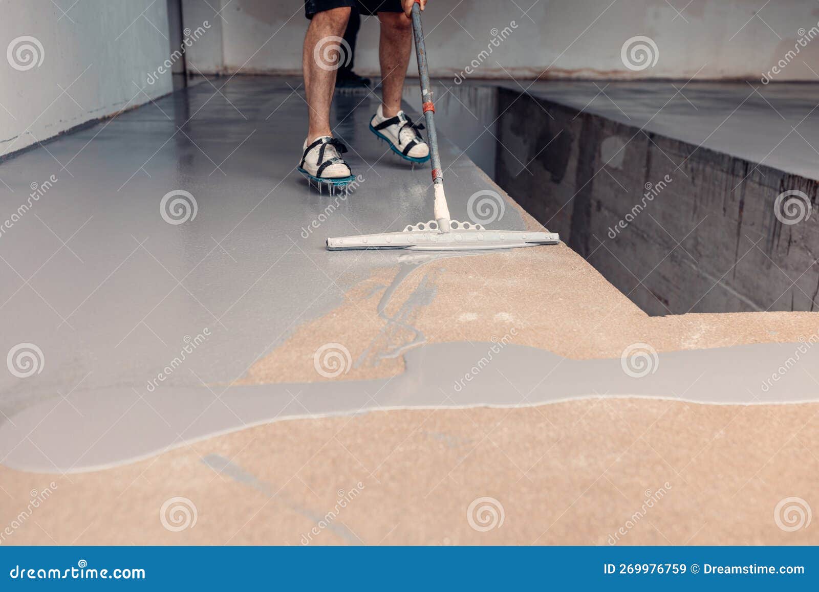 Worker Apply Grey Epoxy Resin in an Industrial Warehouse Stock Image ...