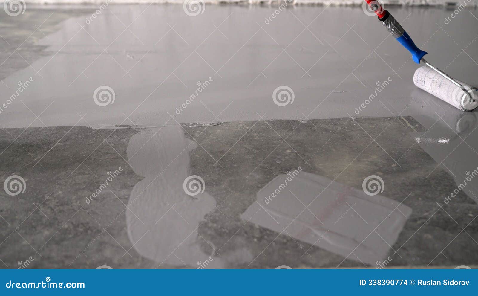 Construction Worker Applying Epoxy Coating on Concrete Floor Using a ...
