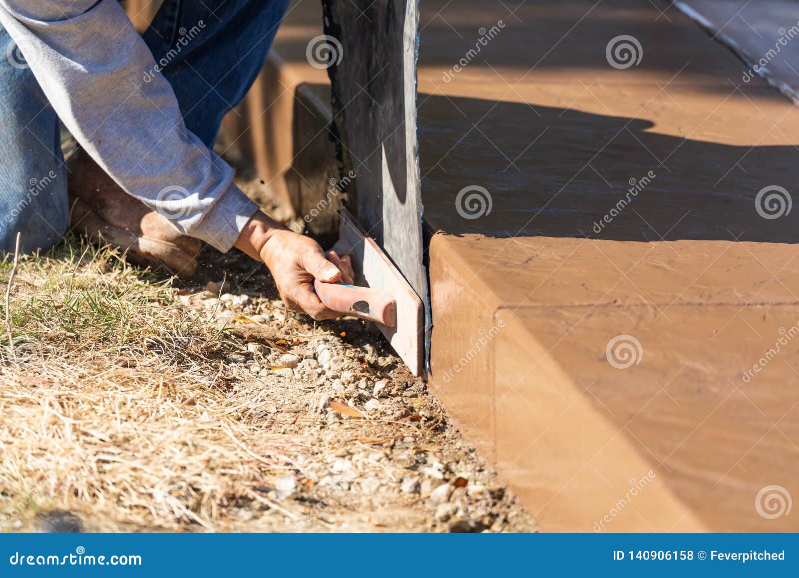 Construction Worker Applying Pressure To Texture Template on Wet Cement ...
